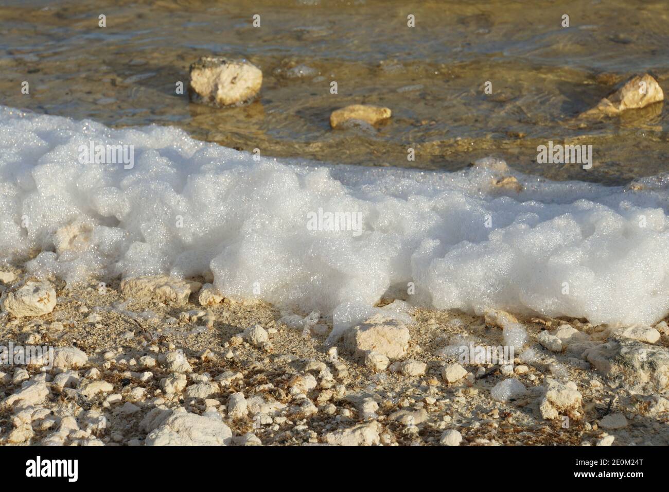 White foam formed on the side of the beach Stock Photo - Alamy