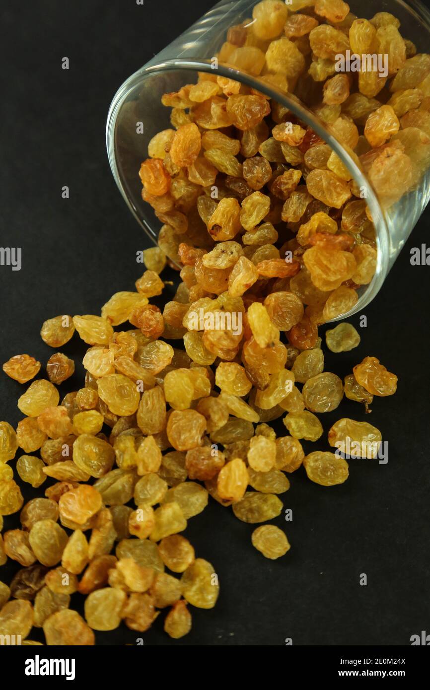 Dried raisins on white background Stock Photo - Alamy