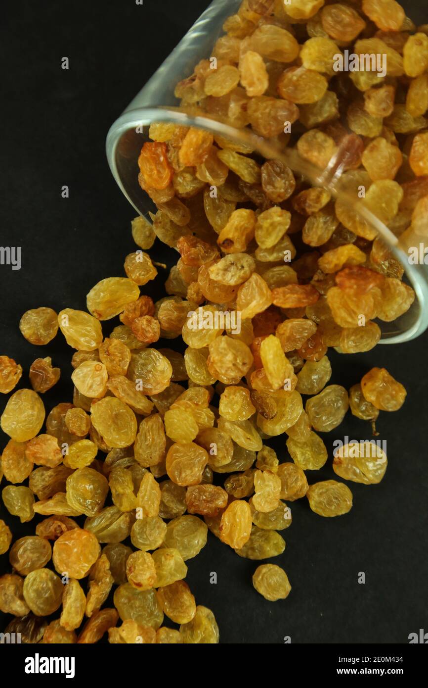 Dried raisins on white background Stock Photo - Alamy