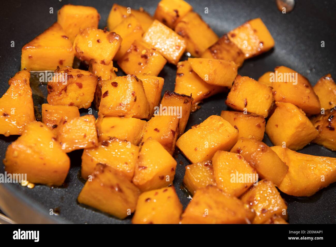 Diced butternut squash being cooked in a pan Stock Photo - Alamy