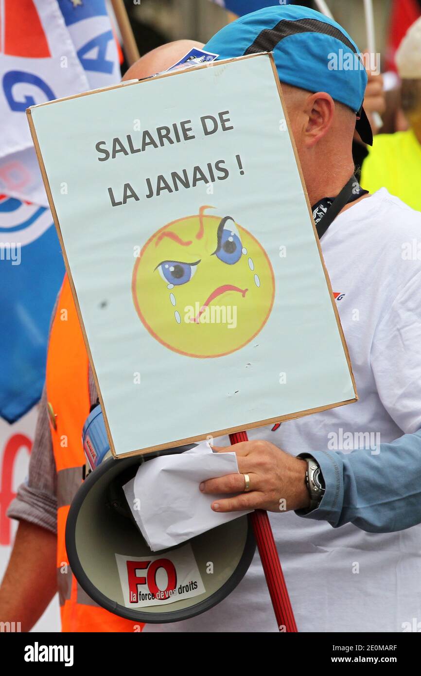 An employee of French automaker Peugeot-Citroen (PSA) protests against ...
