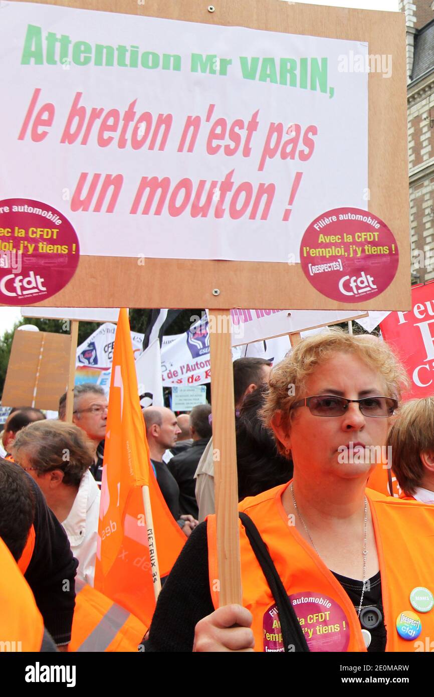 An employee of French automaker Peugeot-Citroen (PSA) protests against ...