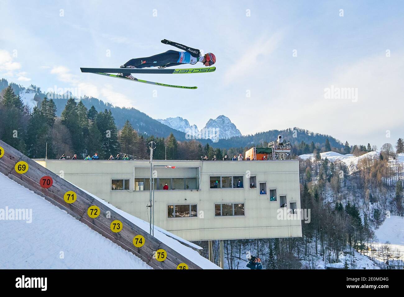 Karl GEIGER, GER in action in front of Zugspitze mountain and referee ...