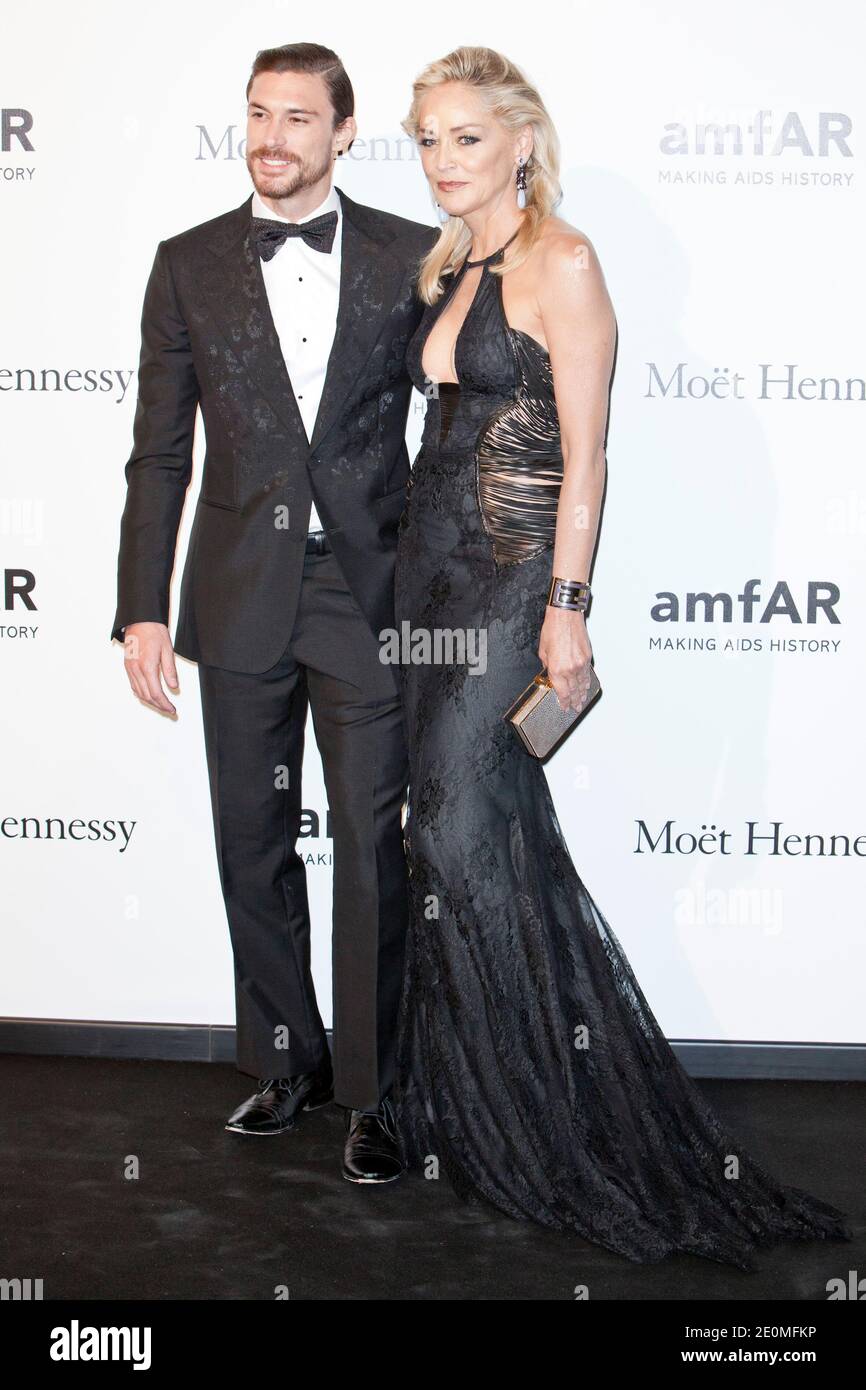 Martin Mica, Sharon Stone attending amfAR Milano 2012 during Milan ...