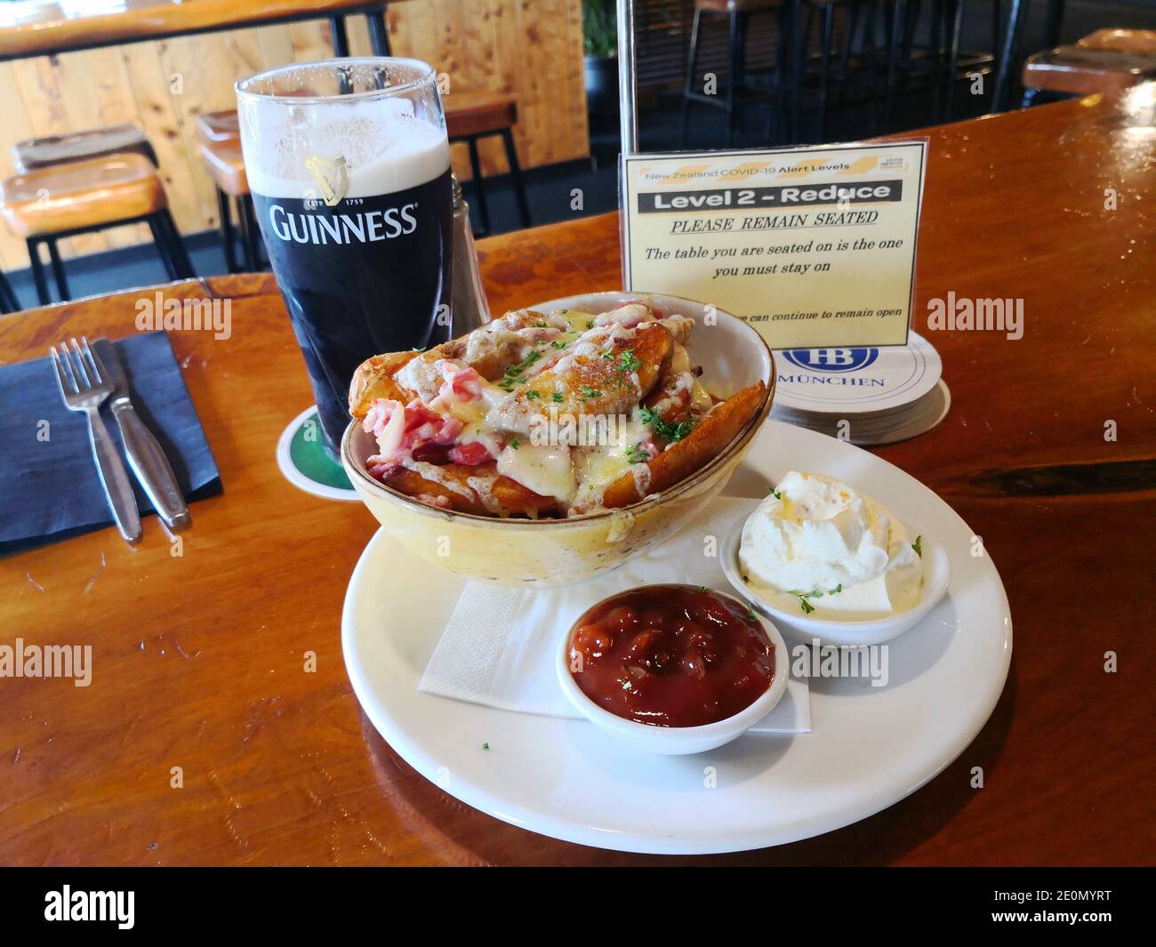 Pub Lunch, a pint of Guinness and a burger and fries Stock Photo - Alamy