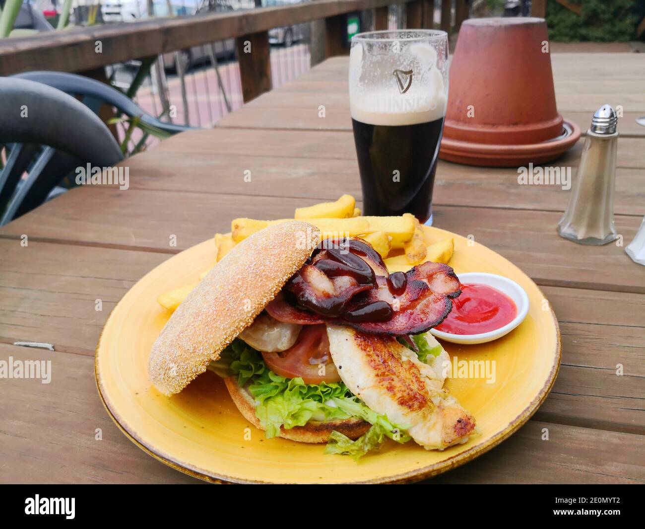 Pub Lunch, a pint of Guinness and a burger and fries Stock Photo - Alamy