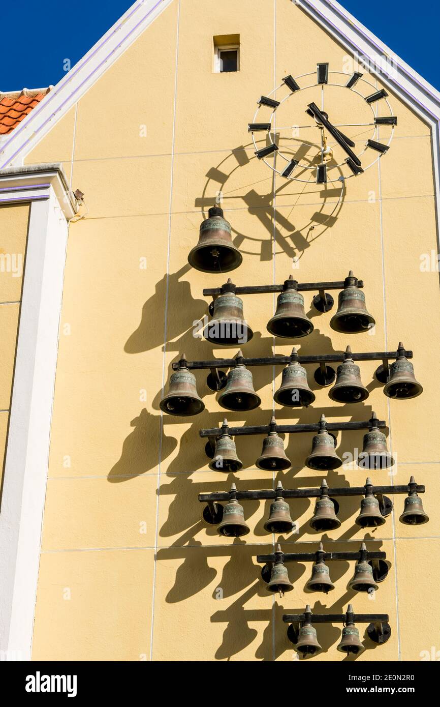 Bell chime clock on wall of building in Willemstad, Curacao Stock Photo ...