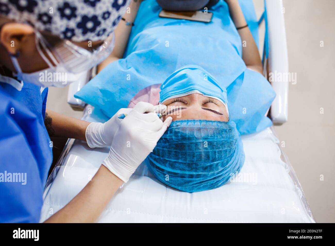 Latin woman Beautician Doing Eyebrow Tattooing For Female ...