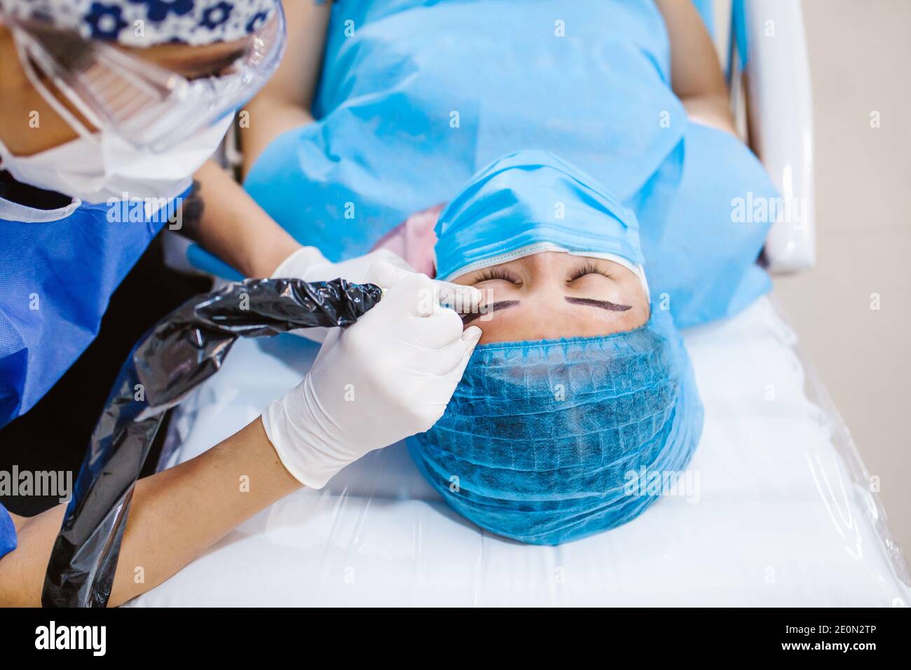 Latin woman Beautician Doing Eyebrow Tattooing For Female ...