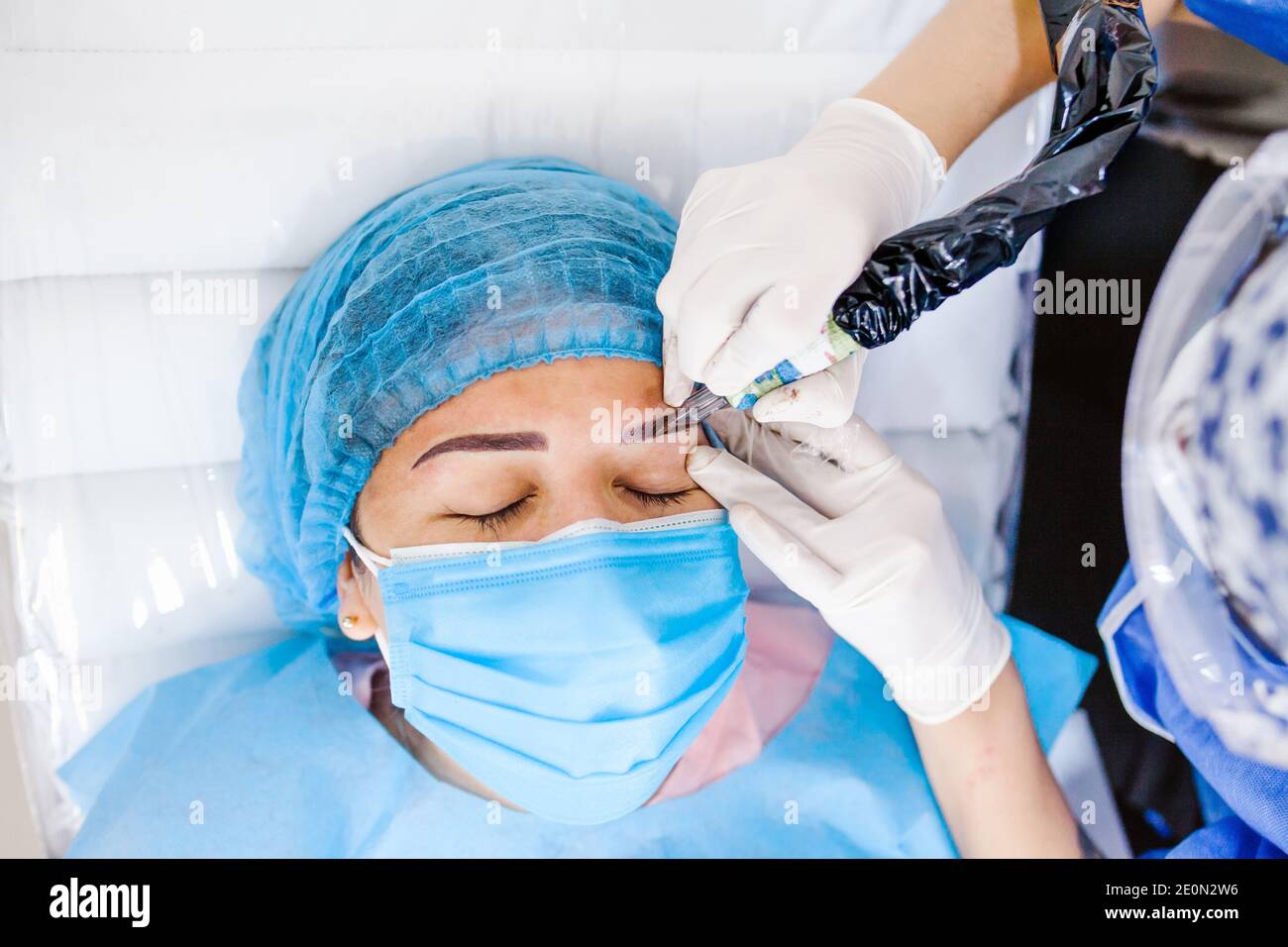 Latin woman Beautician Doing Eyebrow Tattooing For Female ...
