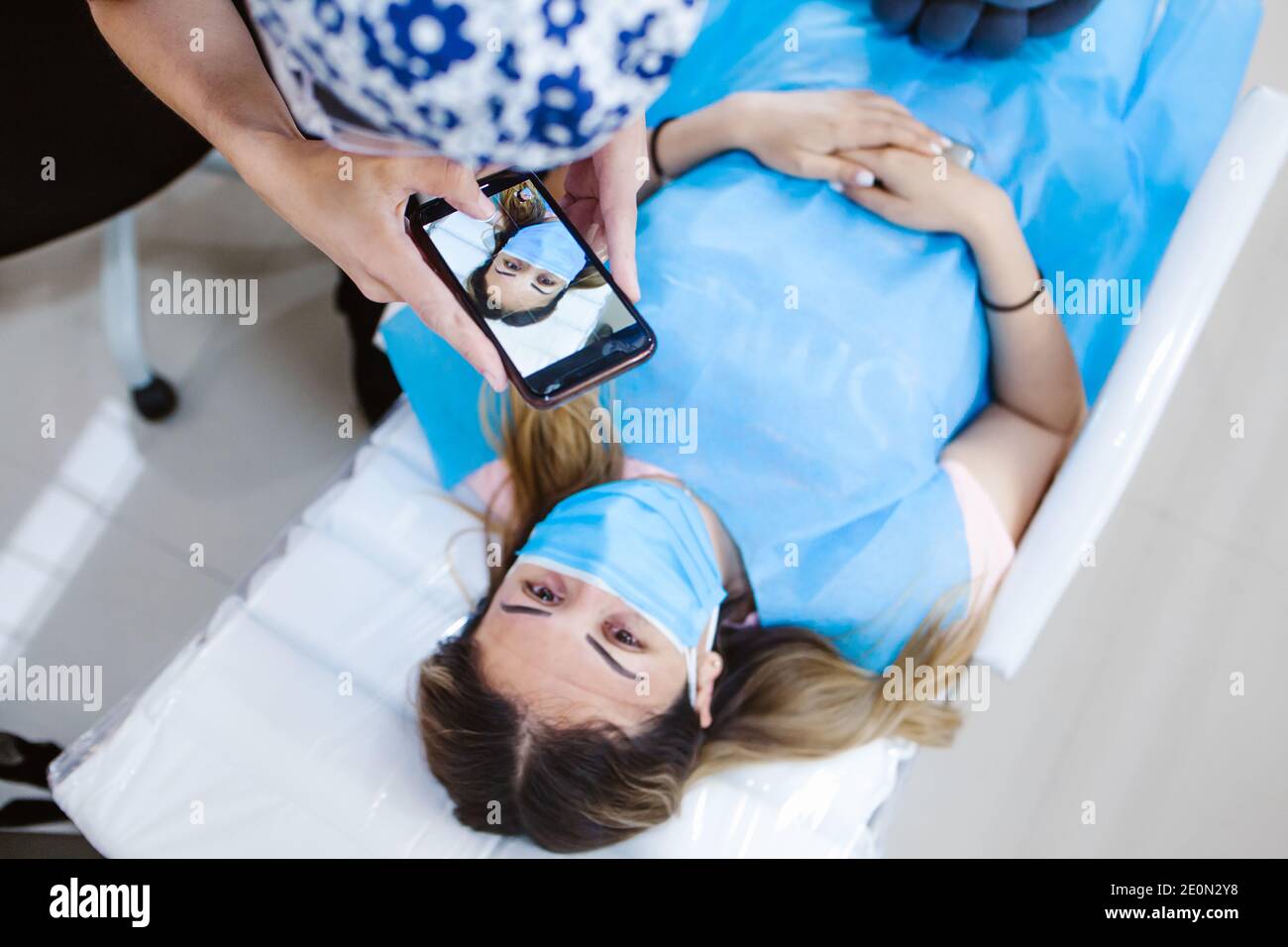 Latin woman Beautician Doing Eyebrow Tattooing For Female ...