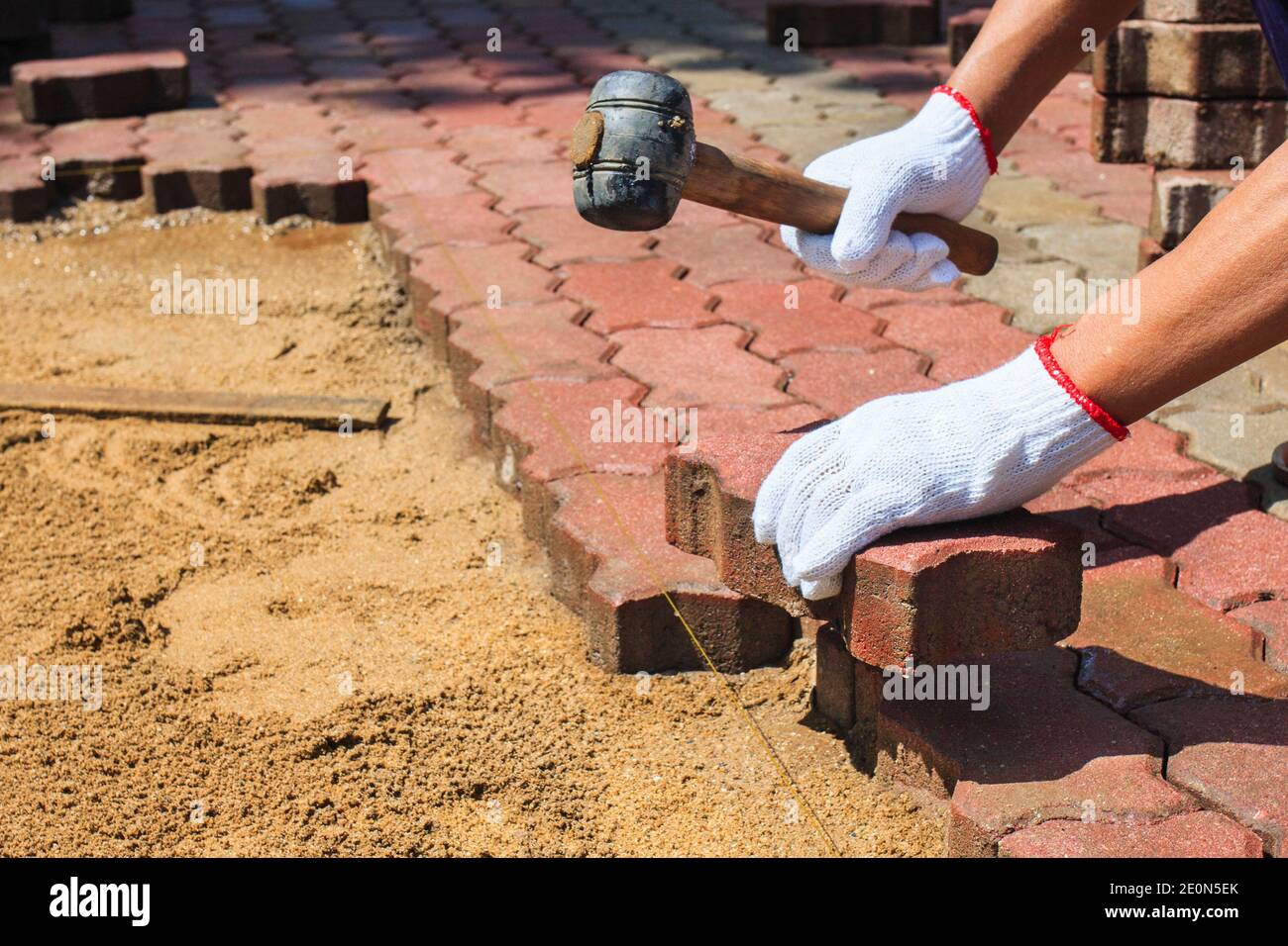 worker laying red concrete paving blocks Stock Photo - Alamy
