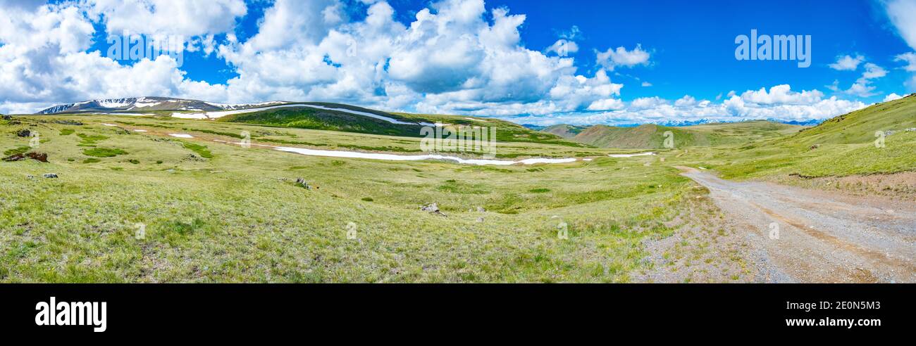 Alpine steppe in the background of snowy mountains. Altai Mountains ...