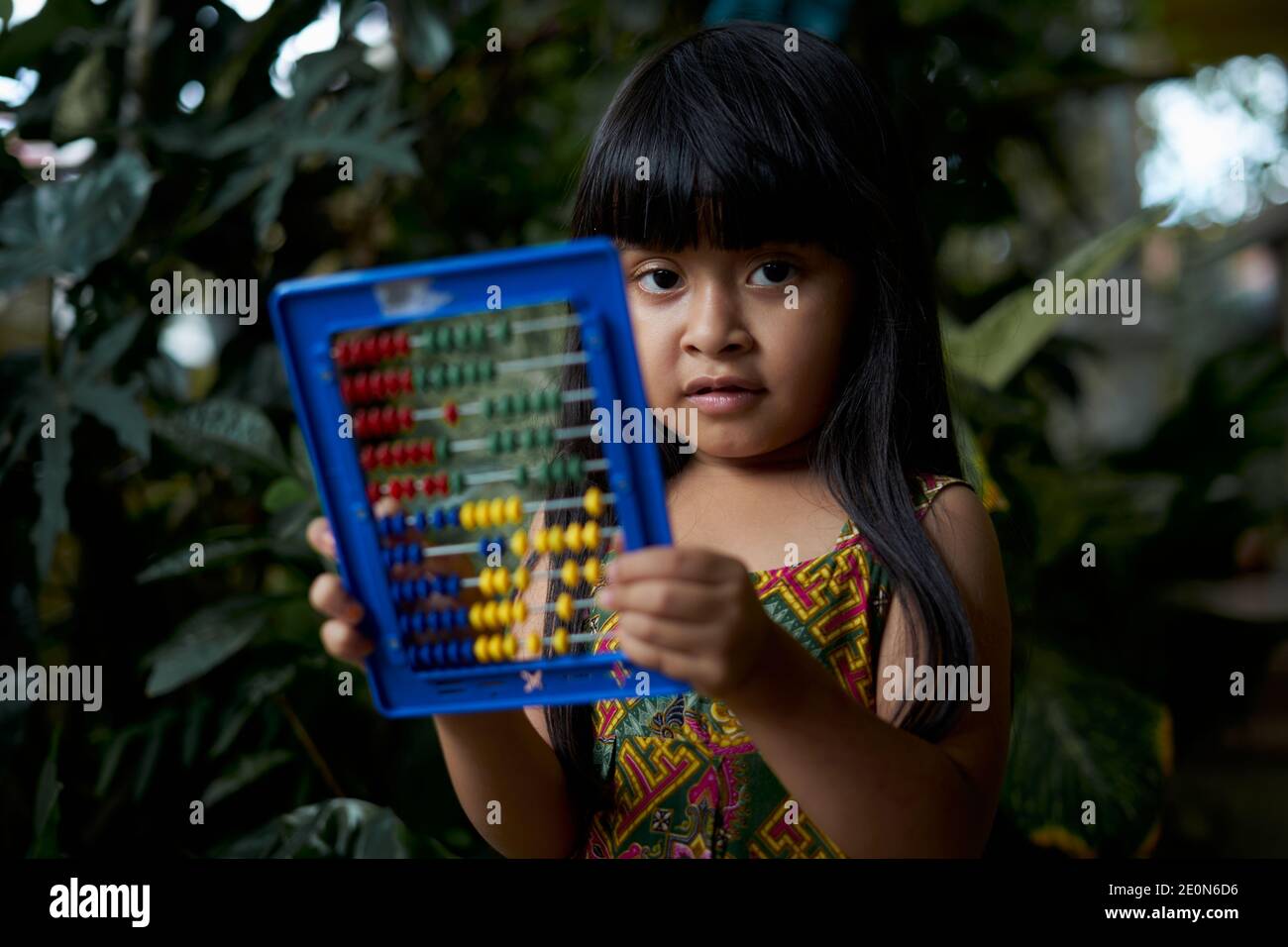 Cute little girl learn counting and Mathematics using abacus at park ...