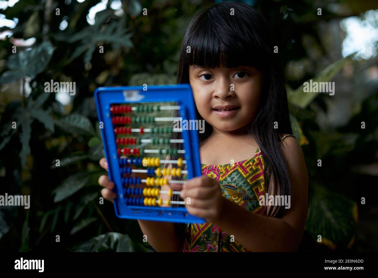 Cute little girl learn counting and Mathematics using abacus at park ...