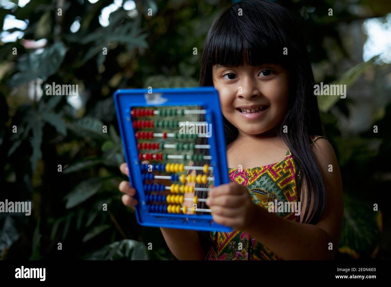 Cute little girl learn counting and Mathematics using abacus at park ...