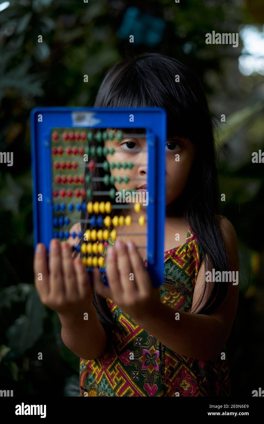 Cute little girl learn counting and Mathematics using abacus at park ...