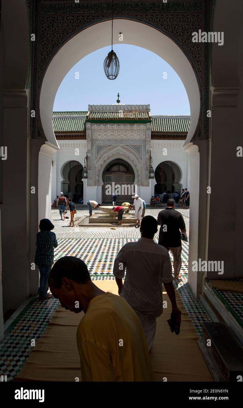 Worshippers enter the Karouing Mosque inside the Fez medina in Morocco ...