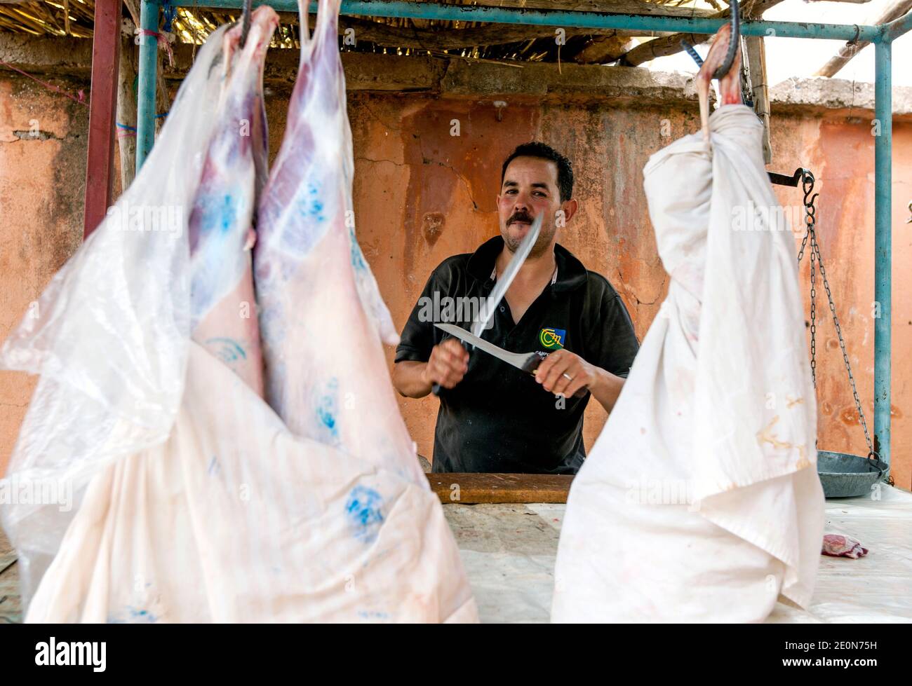 A butcher sharpens his knives at the Tahanoute market in the High Atlas ...