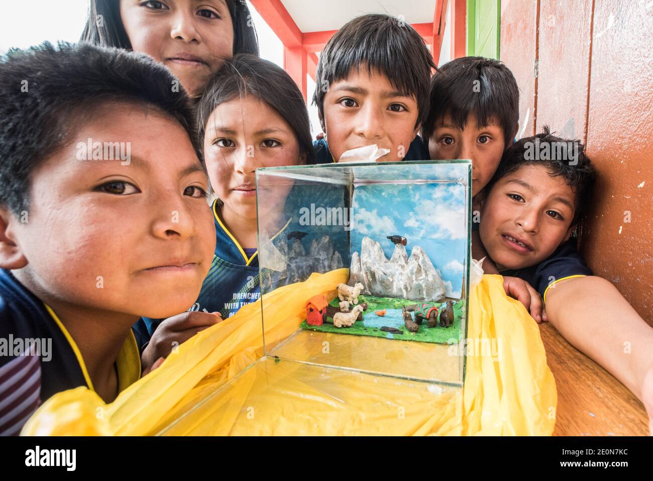 Young children in a peruvian primary school gather around a school ...