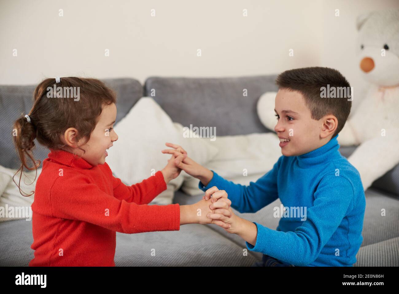 Boy and girl holding hands while playing together. Childhood Stock ...