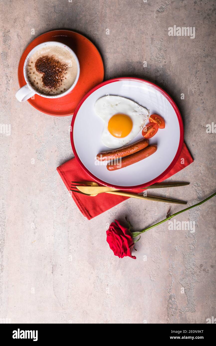 Valentine's day breakfast concept. Valentines fried eggs in the shape of a heart, coffee with ...