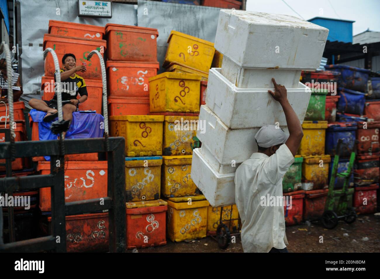 28.06.2014, Yangon, Myanmar, Asia - A worker carries empty cooling ...