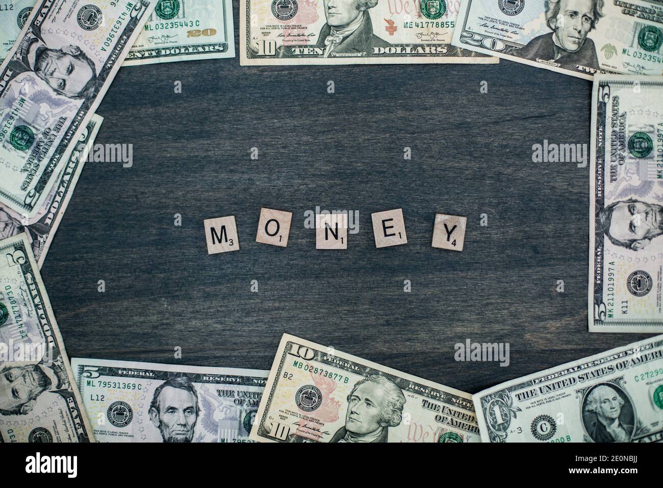 money letter tiles with bills Stock Photo - Alamy
