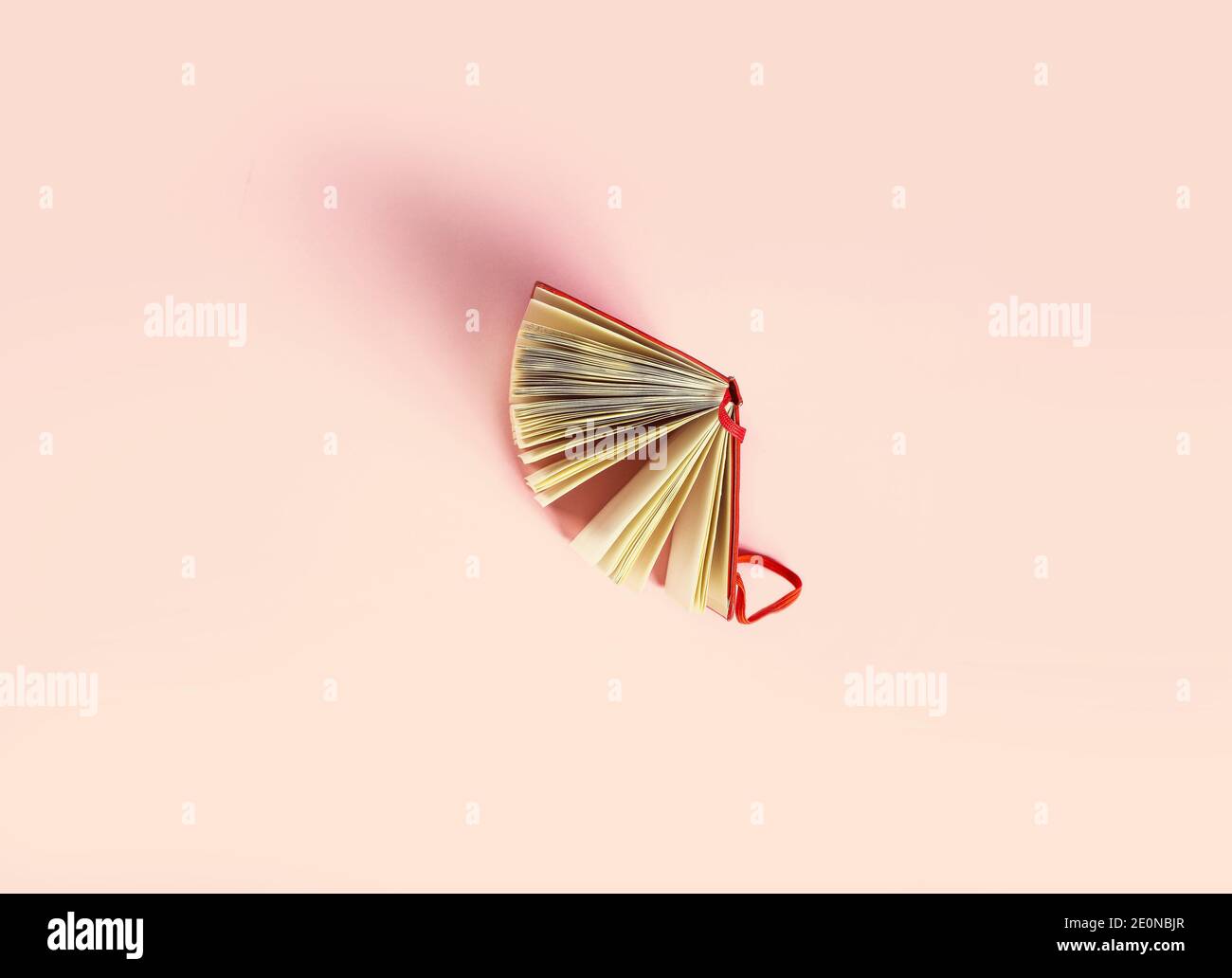 open book standing up on a pink background Stock Photo - Alamy