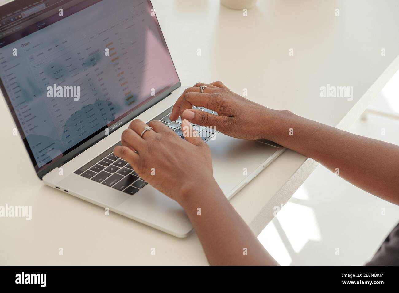 store owners hands typing away Stock Photo - Alamy