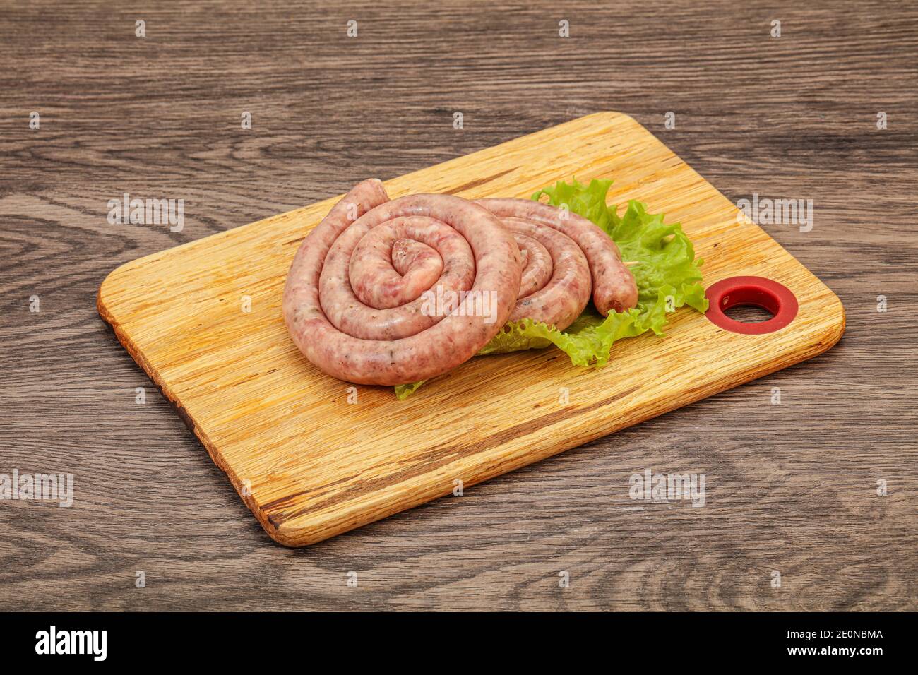 Raw pork sausage ring for grill Stock Photo - Alamy