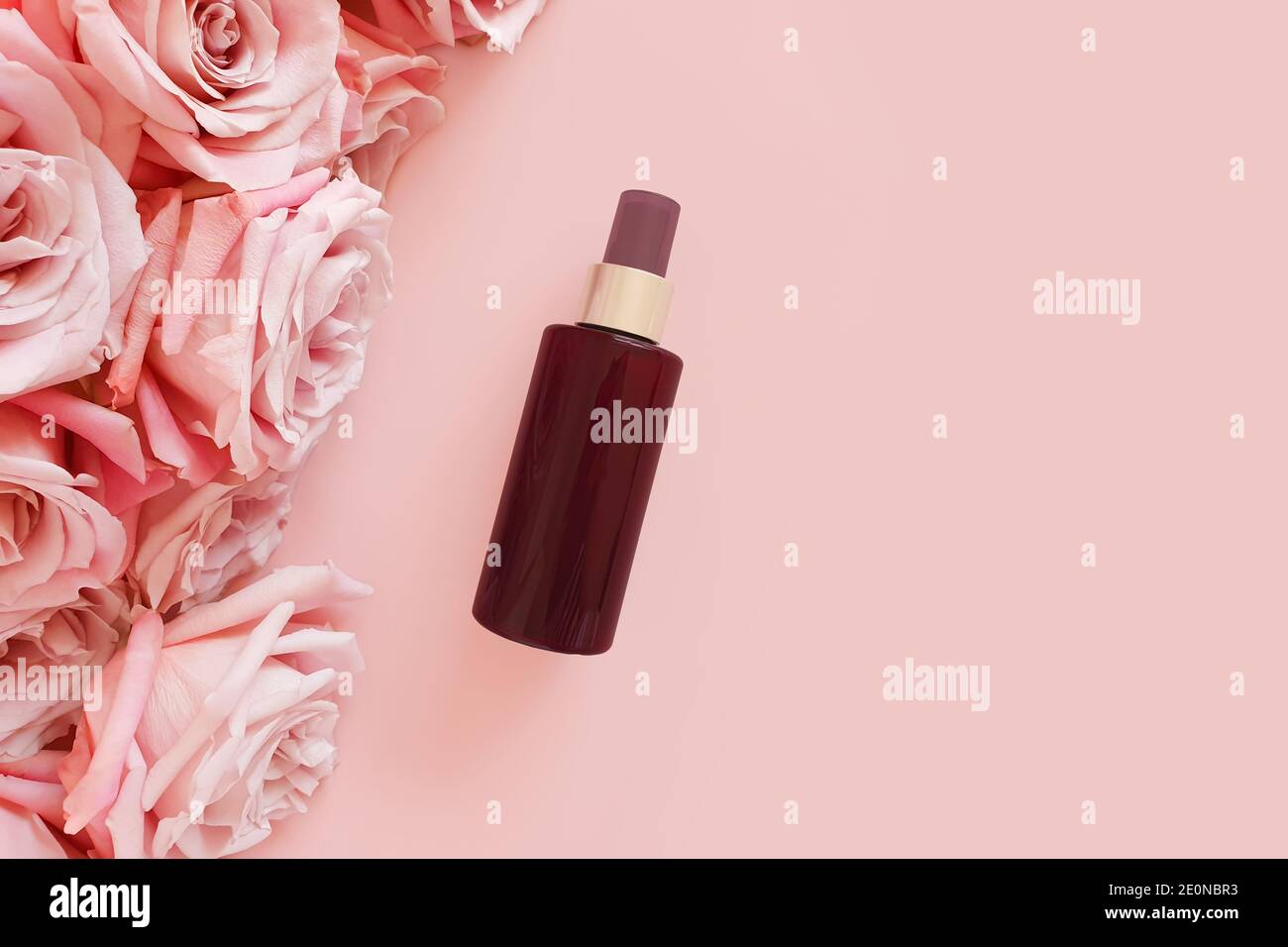 Top view of mockup of unbranded brown plastic spray bottle and pink ...