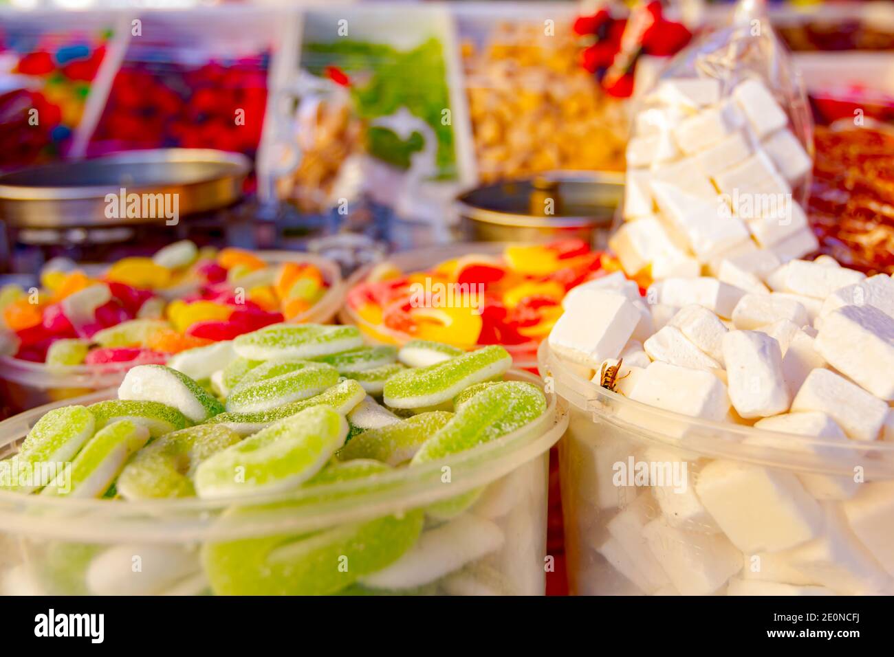 Various colored candies and sweets for sale placed in trays, available ...