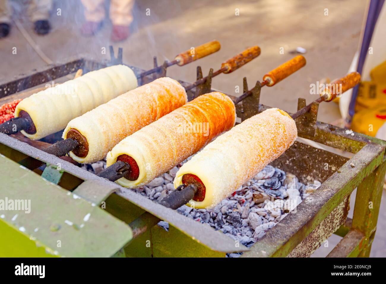 Traditional Hungarian spit cinnamon, chimney cake is rotate for equal ...