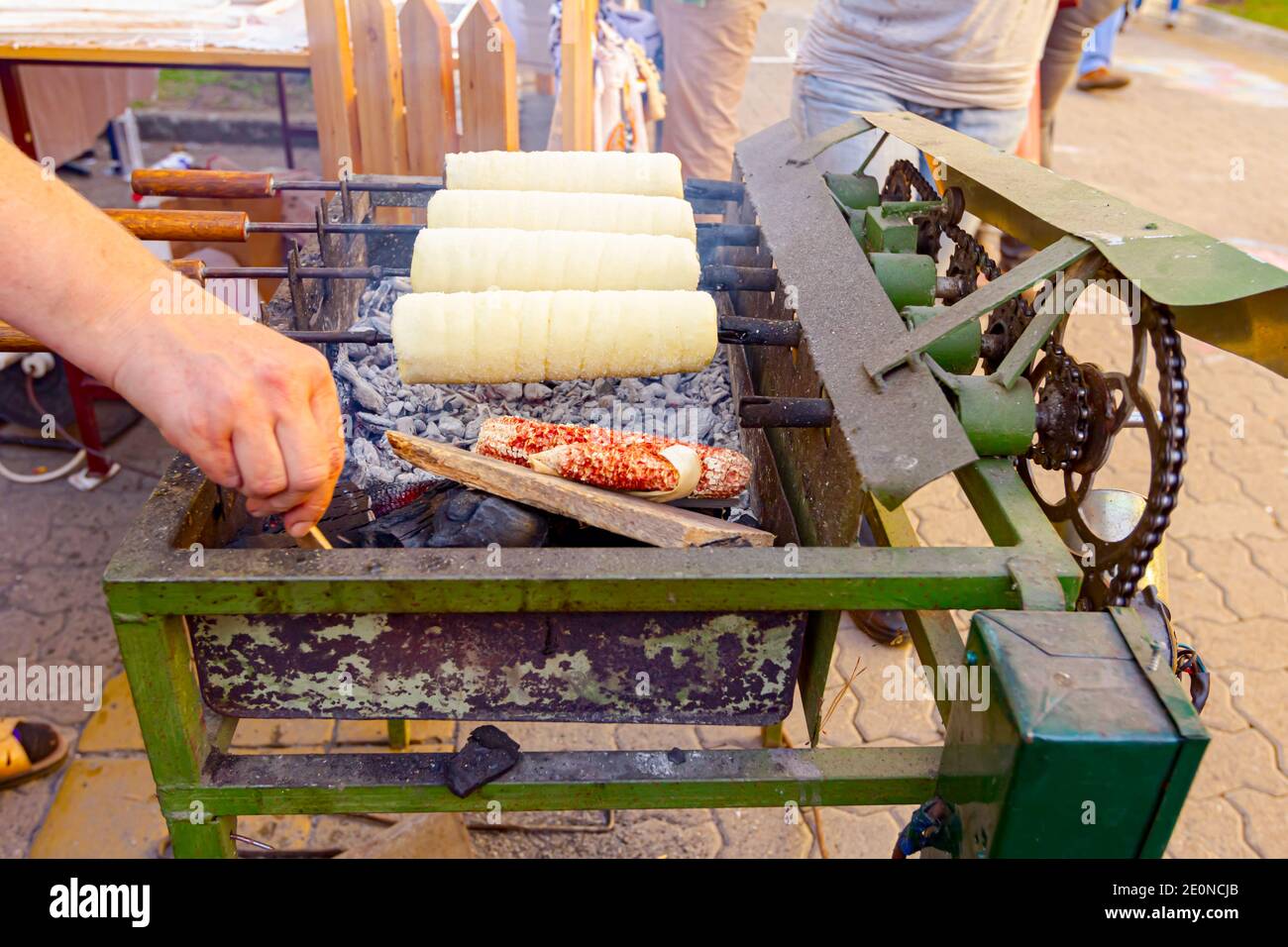 Traditional Hungarian spit cinnamon, chimney cake is rotate for equal ...