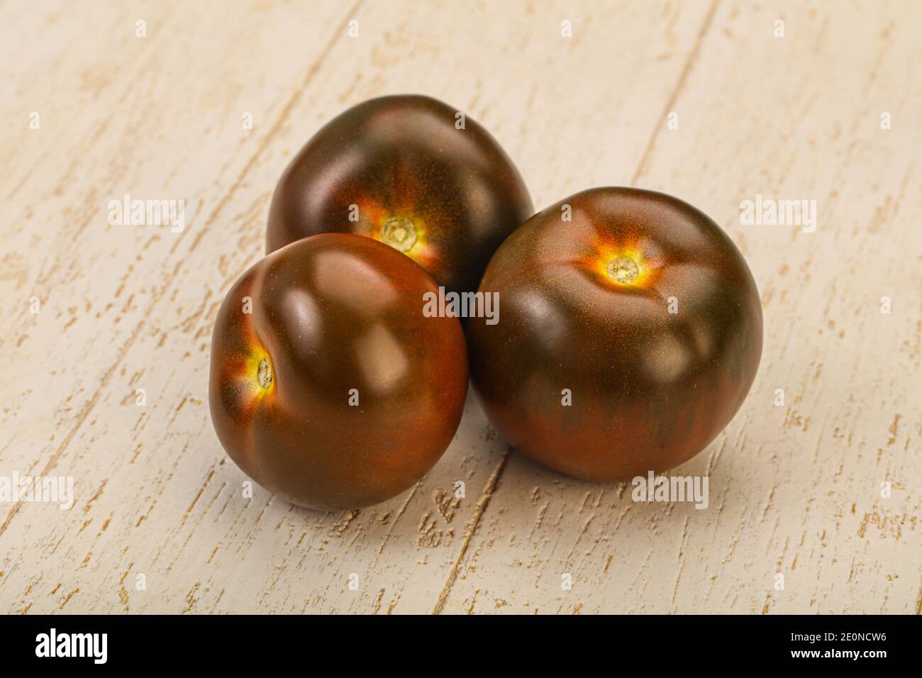 Black tasty juicy kumato tomato heap Stock Photo - Alamy
