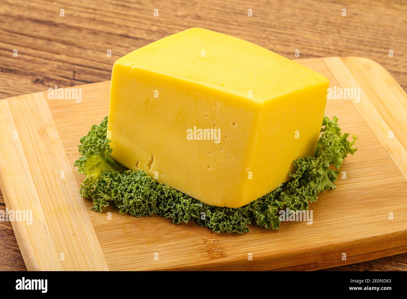 Yellow tilsiter cheese dairy product brick Stock Photo - Alamy