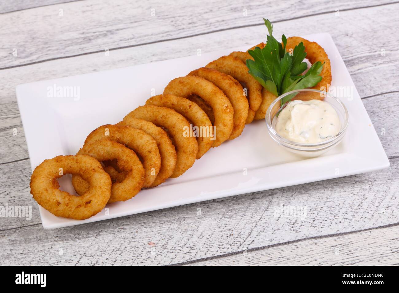 Squid rings snack with sauce served parsley Stock Photo - Alamy