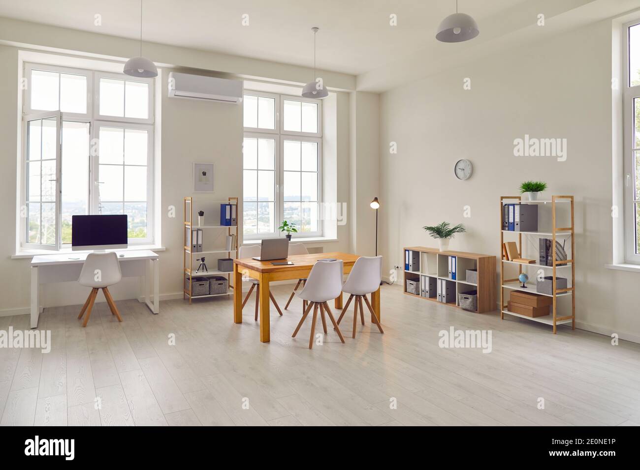 Interior of a new bright modern office with white walls, large windows ...