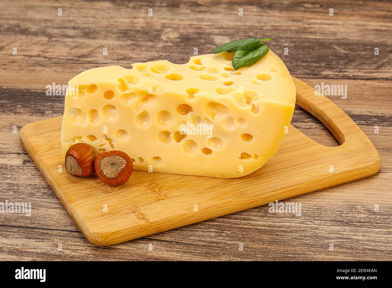 Maasdam cheese - dairy yellow triangle with holes Stock Photo - Alamy