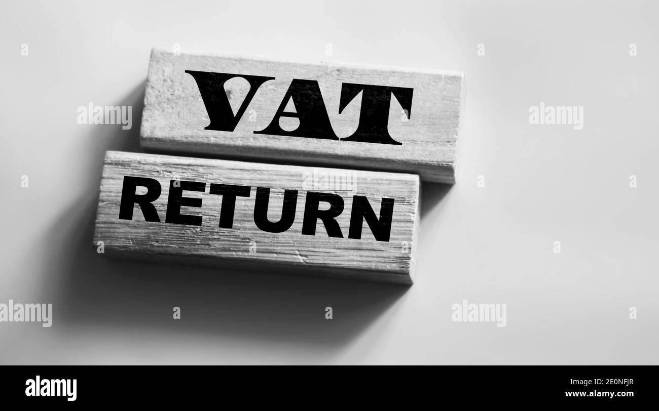 VAT return text Value Added Tax return on wooden blocks on pink ...