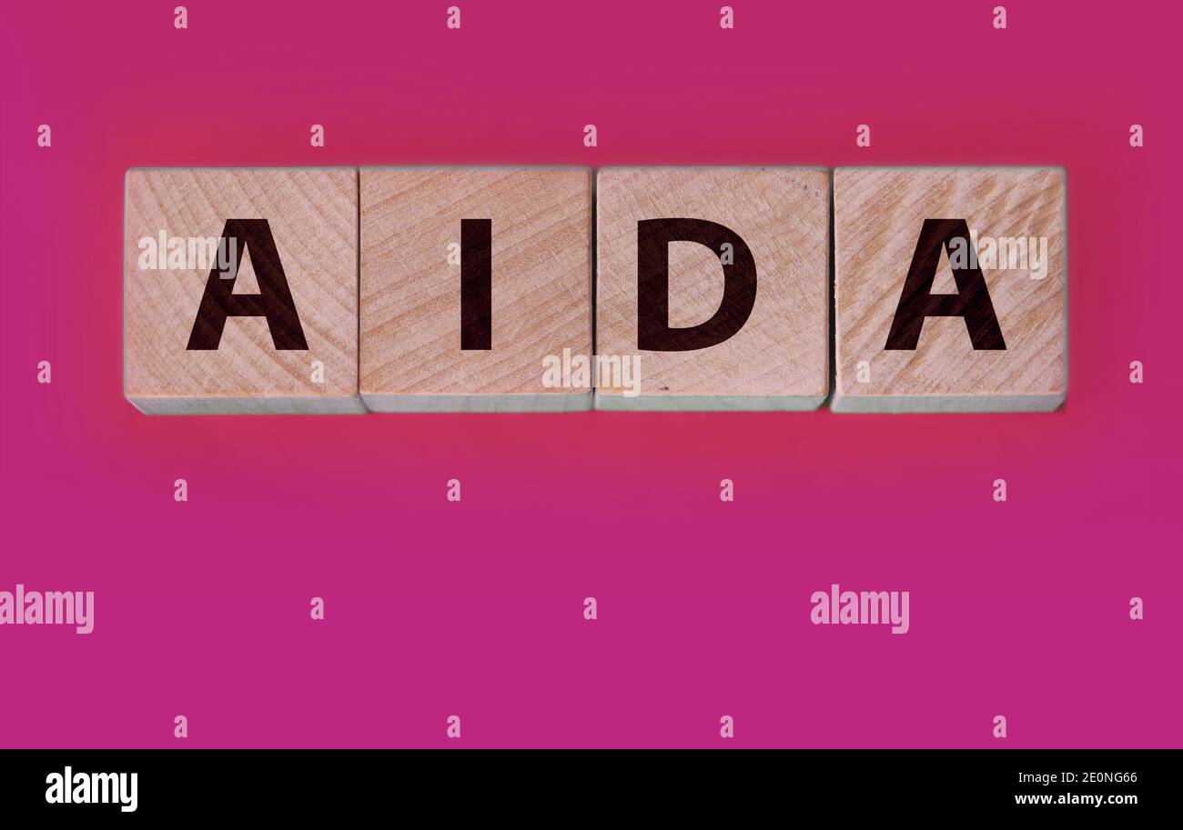 Four wooden cubes with letters AIDA meaning Attention Awareness ...