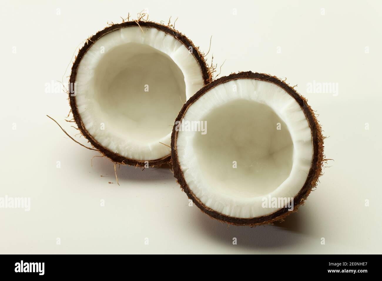 Coconut broken in two parts isolated shot in studio on white background ...