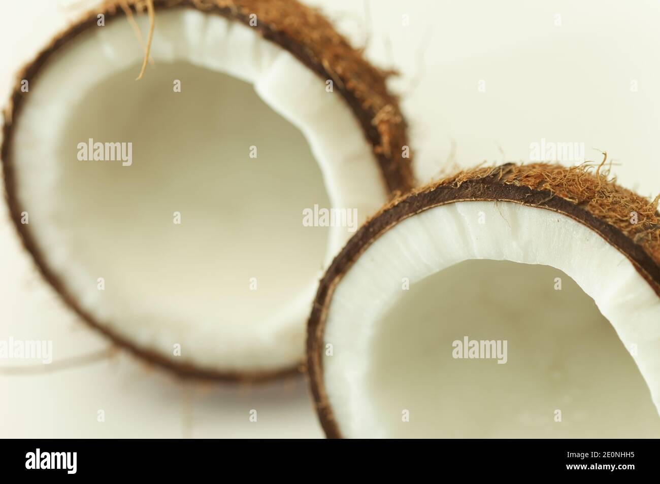 Coconut broken in two parts isolated shot in studio on white background ...