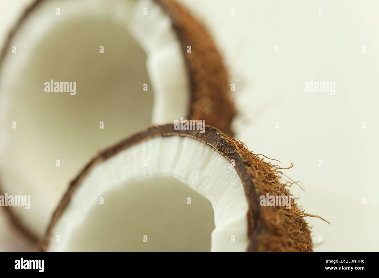 Coconut broken in two parts isolated shot in studio on white background ...