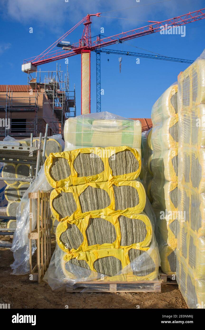 Glass wool packs at construction site. Cranes at bottom Stock Photo - Alamy