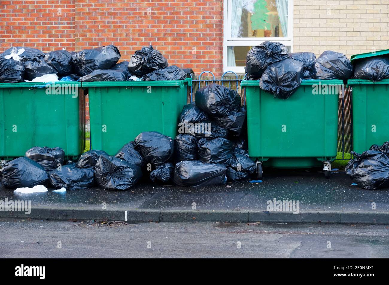 Fly tipping of waste and rubbish black bin bags in residential area ...
