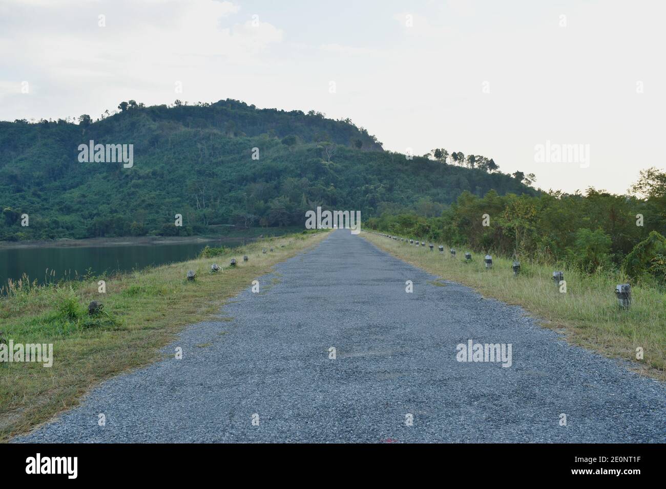 road on water reservoir lake with mountain background Stock Photo - Alamy