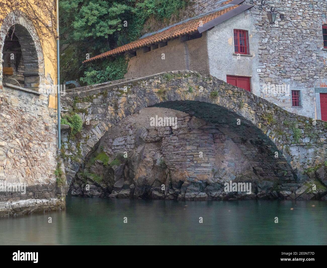 Enchanting glimpse of Como Lake, the medieval bridge in the village of ...