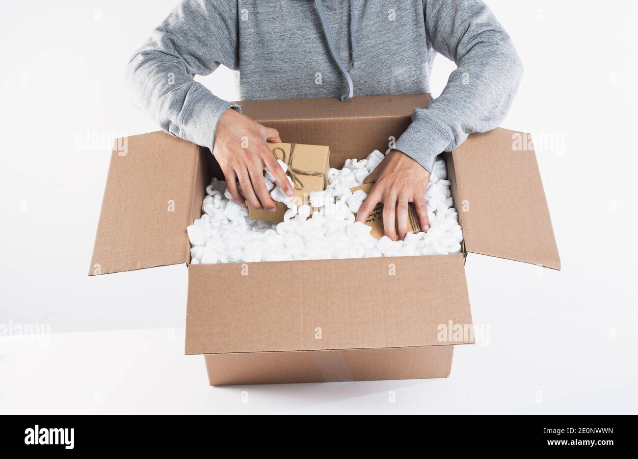 some packages being placed into packing materials Stock Photo - Alamy